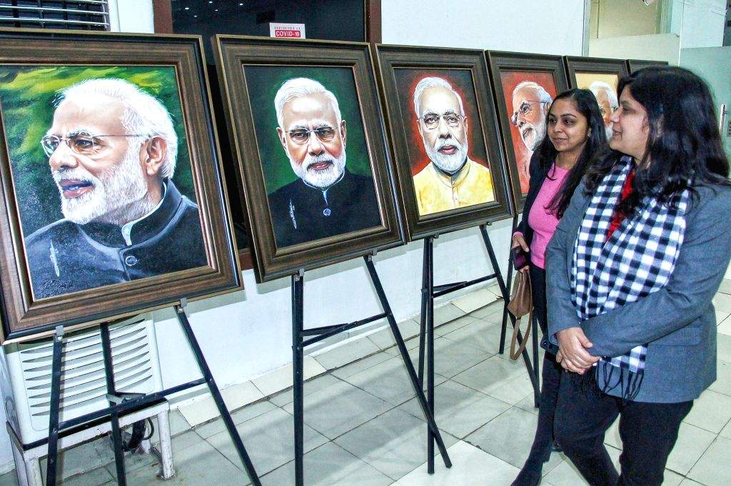 People visit a painting exhibition of Prime Minister Narendra Modi by ...