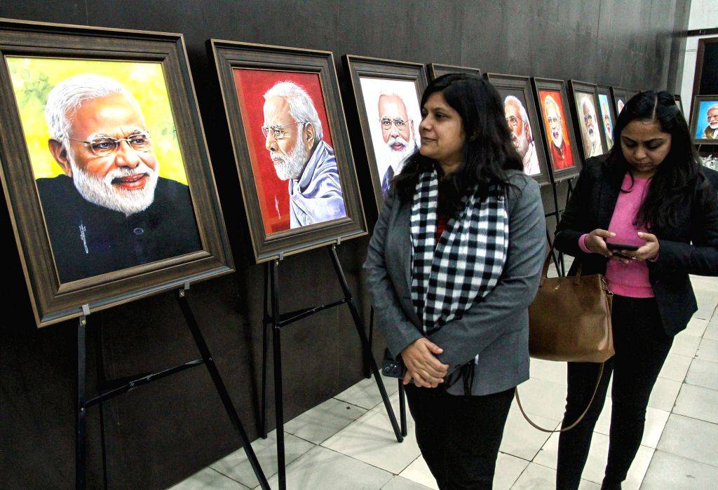 People visit a painting exhibition of Prime Minister Narendra Modi by ...