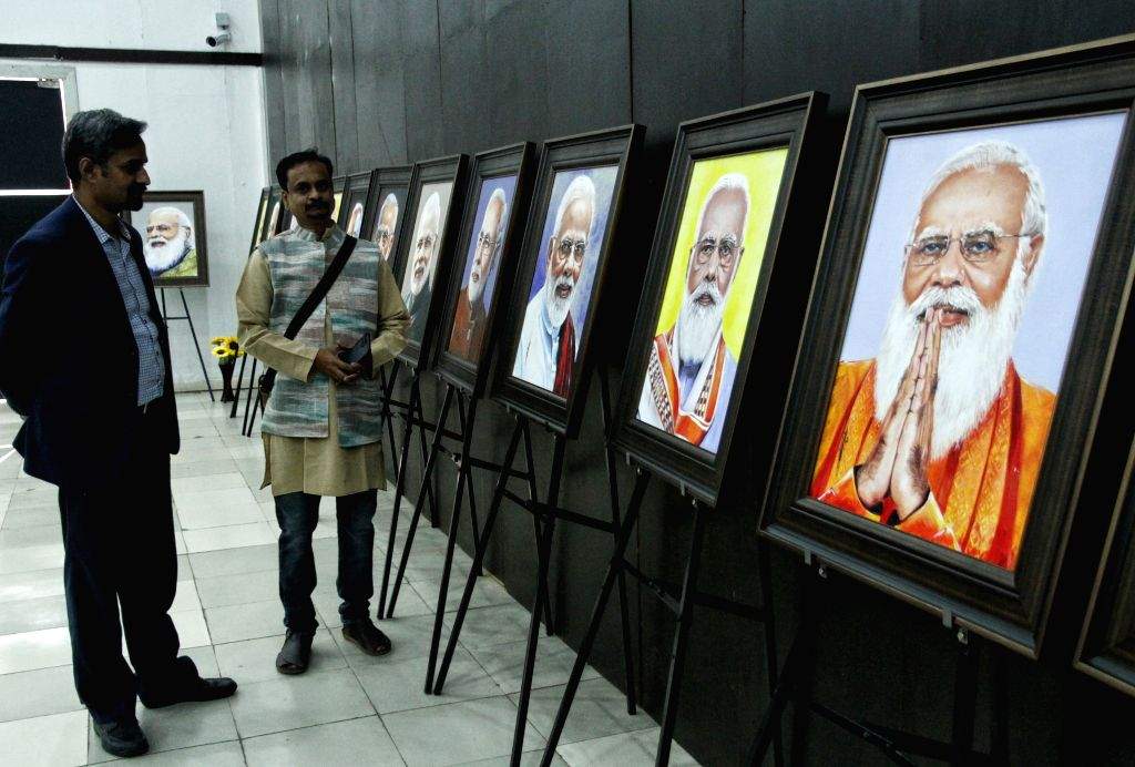 People visit a painting exhibition of Prime Minister Narendra Modi by ...
