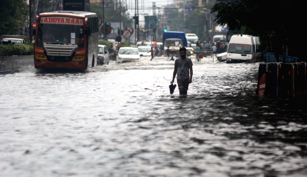 People wade through a Waterlogging road due to heavy rain during ...