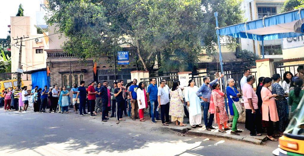People wait in queues to cast their votes for the 2nd phase of Lok ...