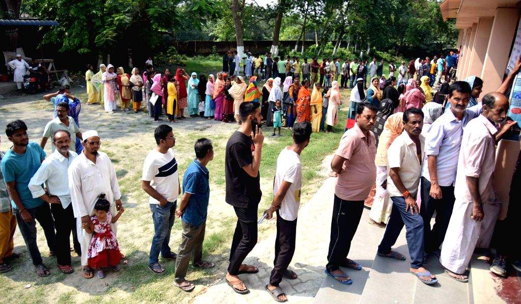 People wait in queues to cast their votes for the 2nd phase of Lok ...