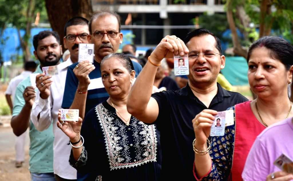 People wait to cast their votes during the 5th phase of Lok Sabha elections