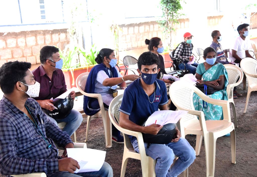People waiting during COVID-19 vaccination drive at KC General Hospital ...