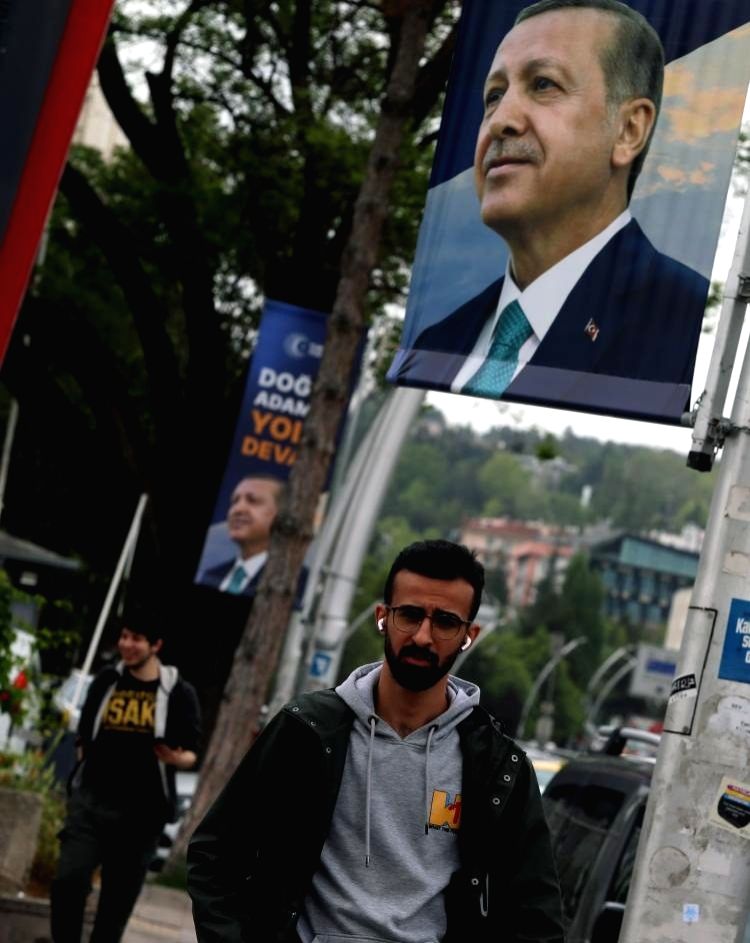Ankara : People walk by an election campaign poster in Ankara