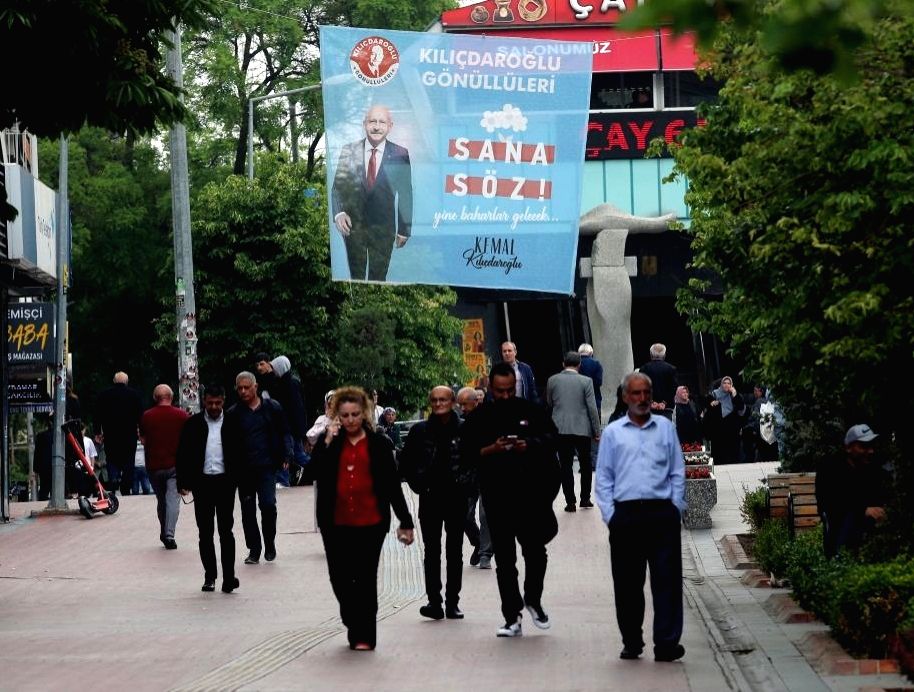 Ankara : People walk by an election campaign poster in Ankara