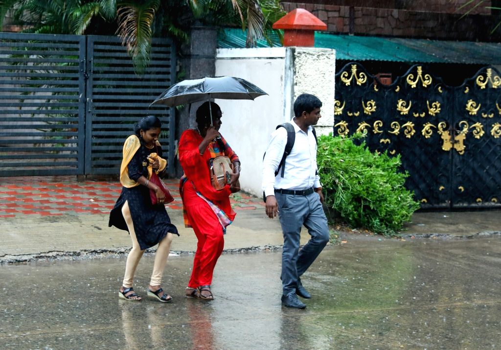 People walk past during rain