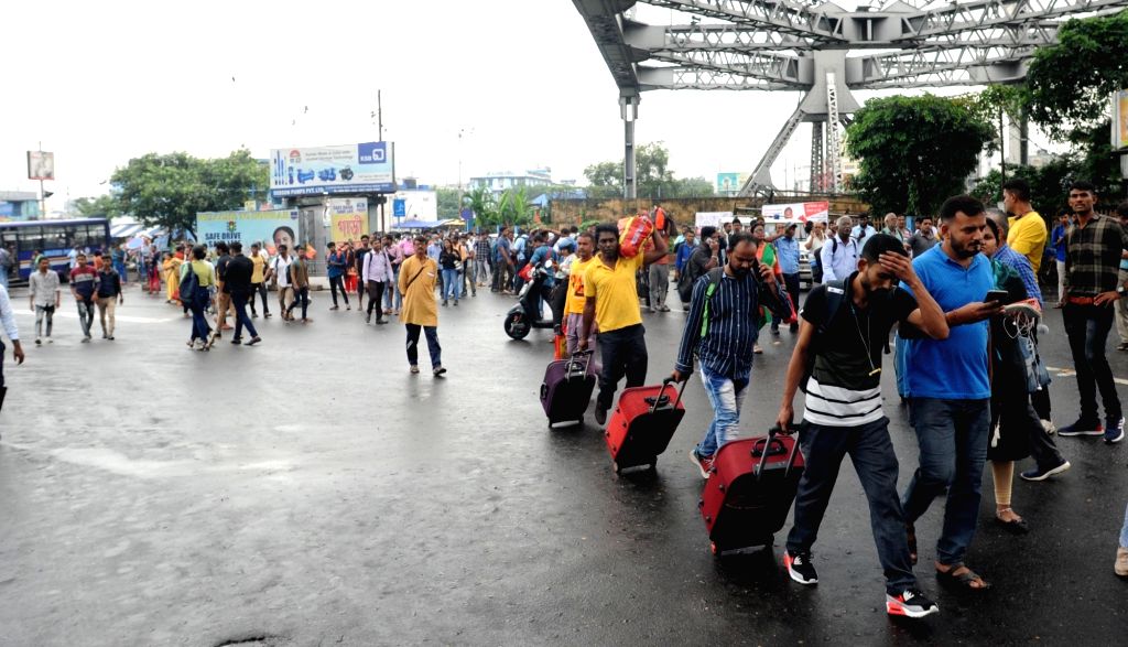 People walk through the Howrah Bridge.