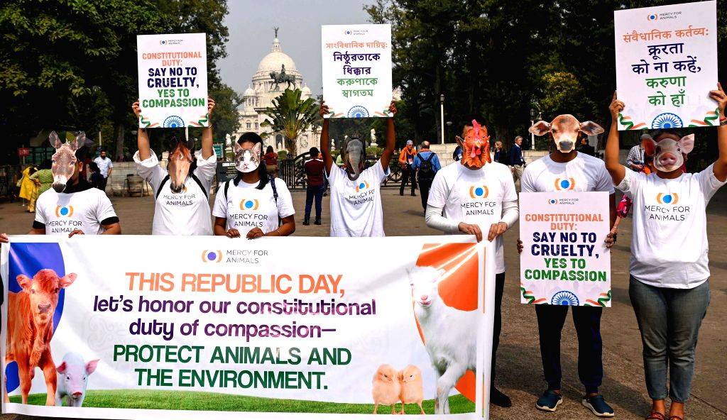 People wearing animal masks take out an awareness march in front of ...
