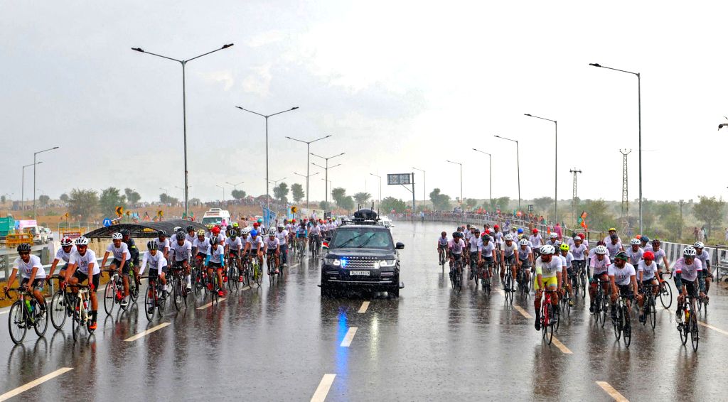 PM Modi's convoy rides along a platoon of cyclists during the roadshow ...