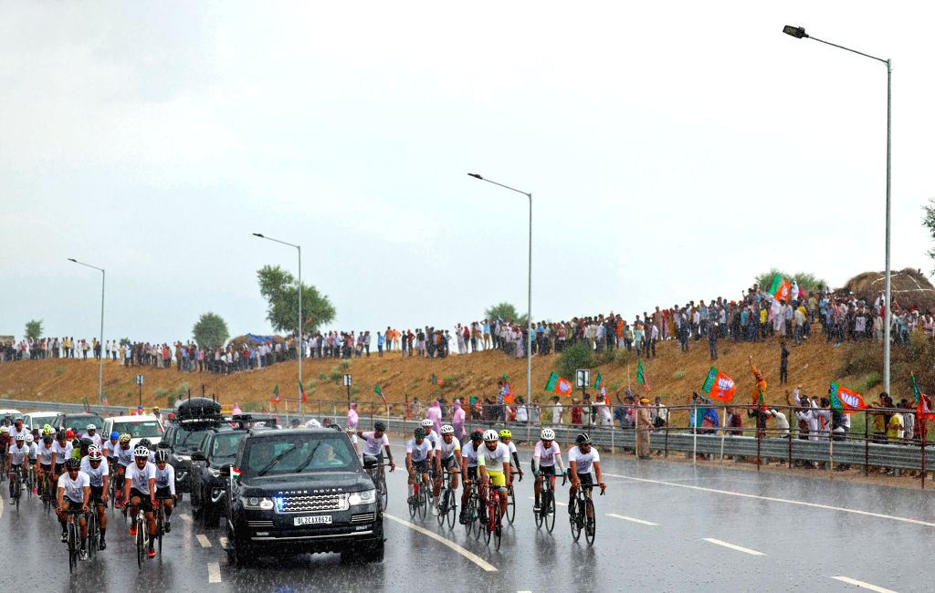 PM Modi's convoy rides along a platoon of cyclists during the roadshow ...