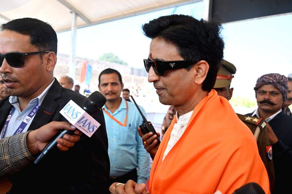 Poet Kumar Vishwas speaks to the media upon his arrival at the Maha ...