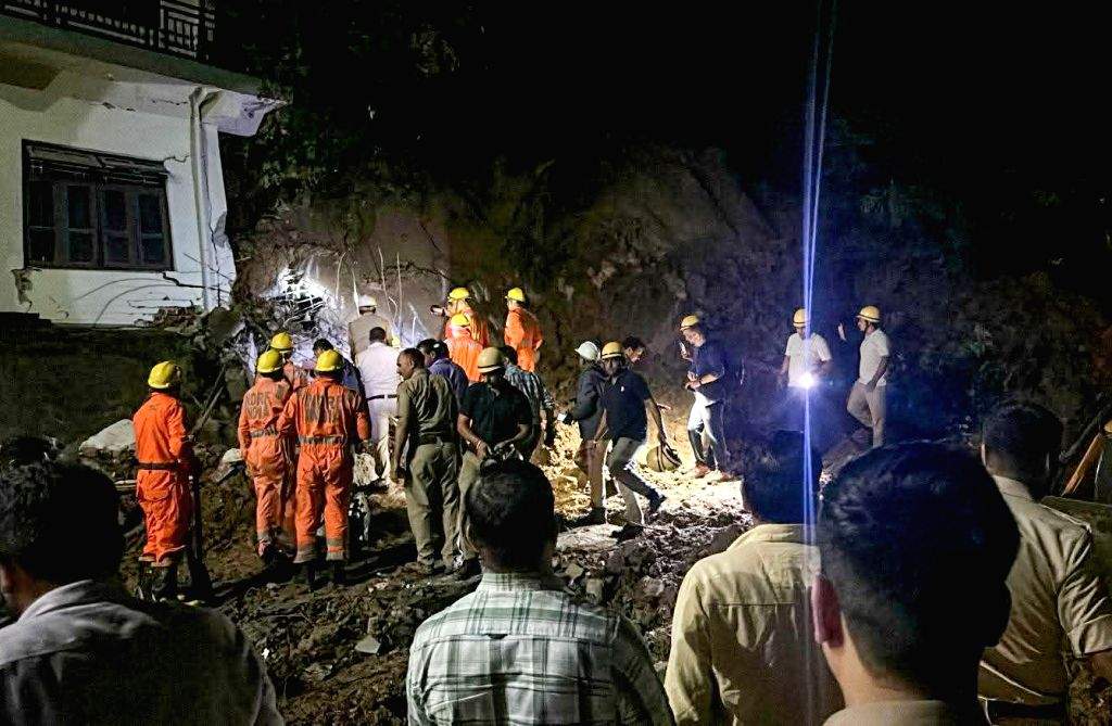 Police and NDRF personnel conduct rescue operations at landslide site