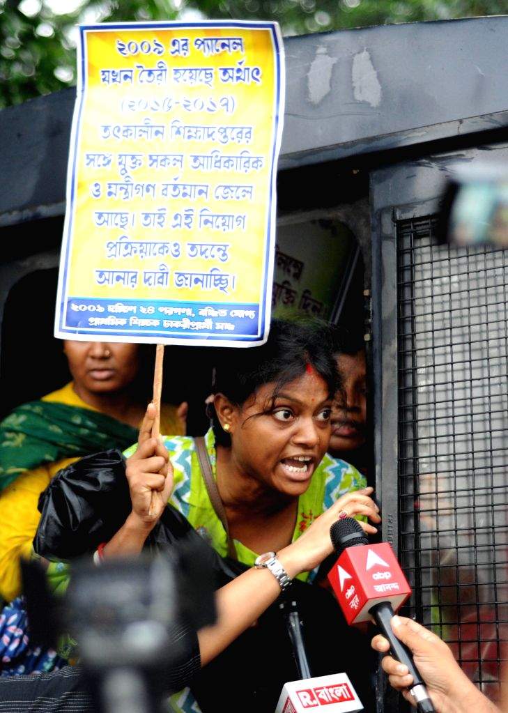 Police personnel detain primary teacher candidates during a protest