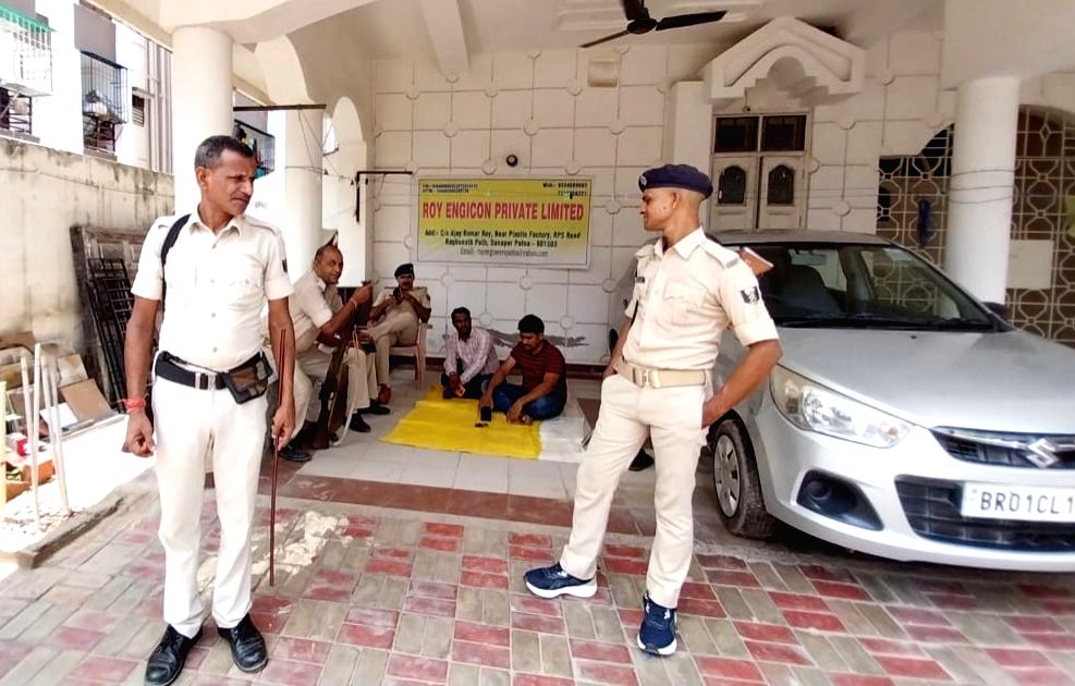 Patna : Police personnel stand in guard during a raid at Engineer ...