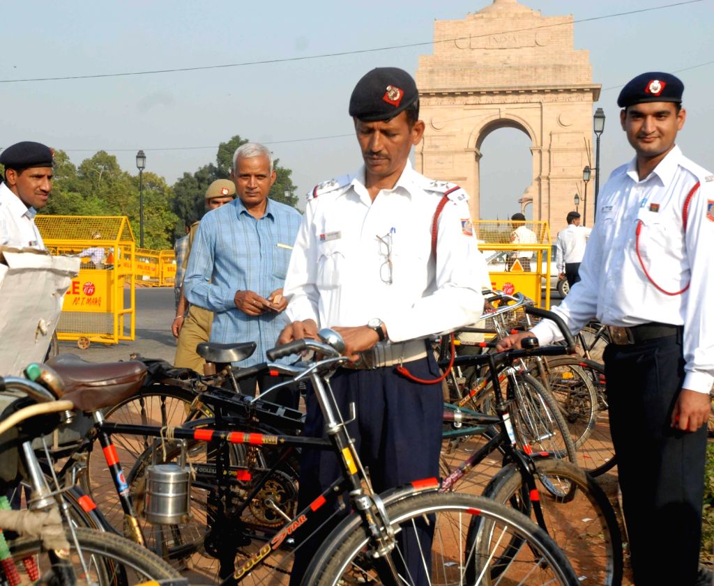 Policemen affix reflector tapes on bicycle during an awareness campaign