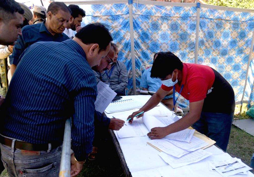 Polling officials checking the election related material for the 2nd ...