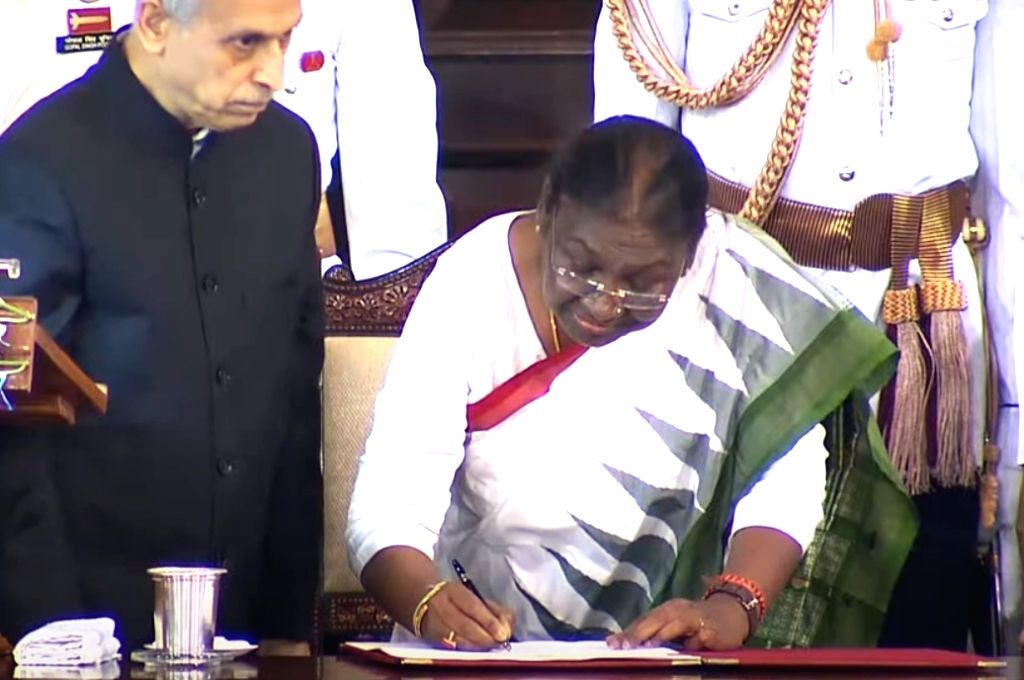 President-elect Droupadi Murmu signs the register after taking oath as ...