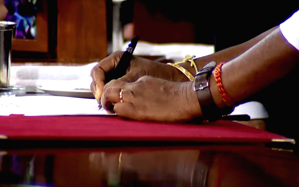 President-elect Droupadi Murmu signs the register after taking oath as ...