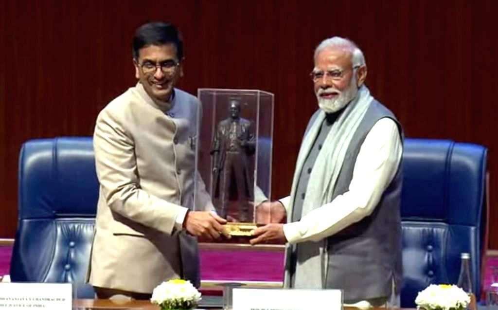 Prime Minister Narendra Modi being presented a memento by Chief Justice ...