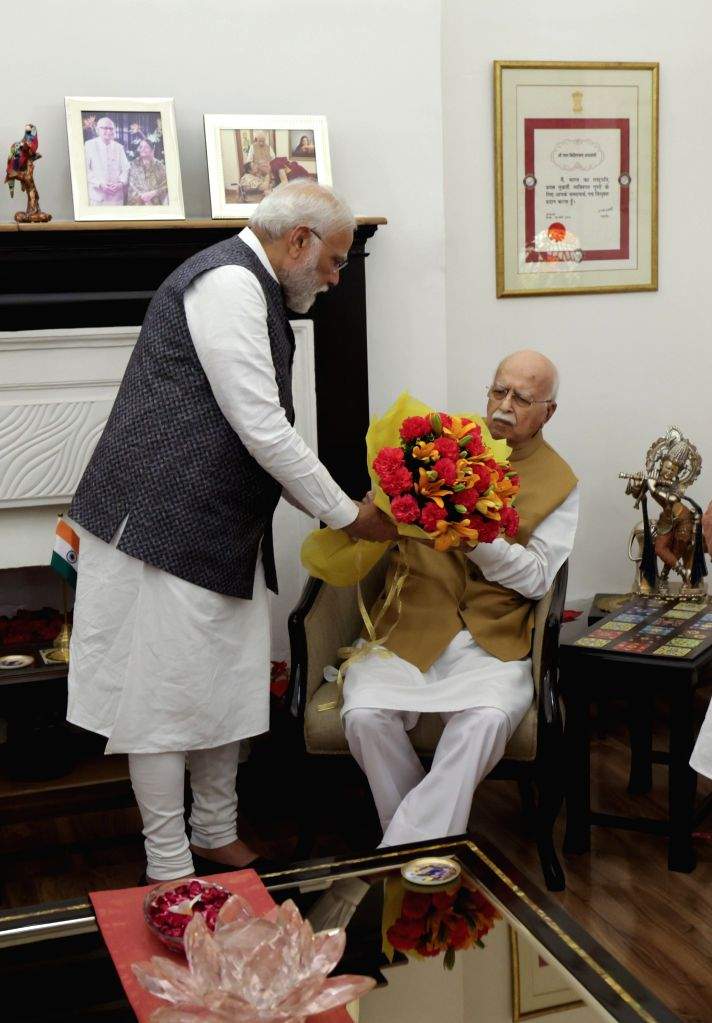 Prime Minister Narendra Modi greets senior BJP leader LK Advani on his ...