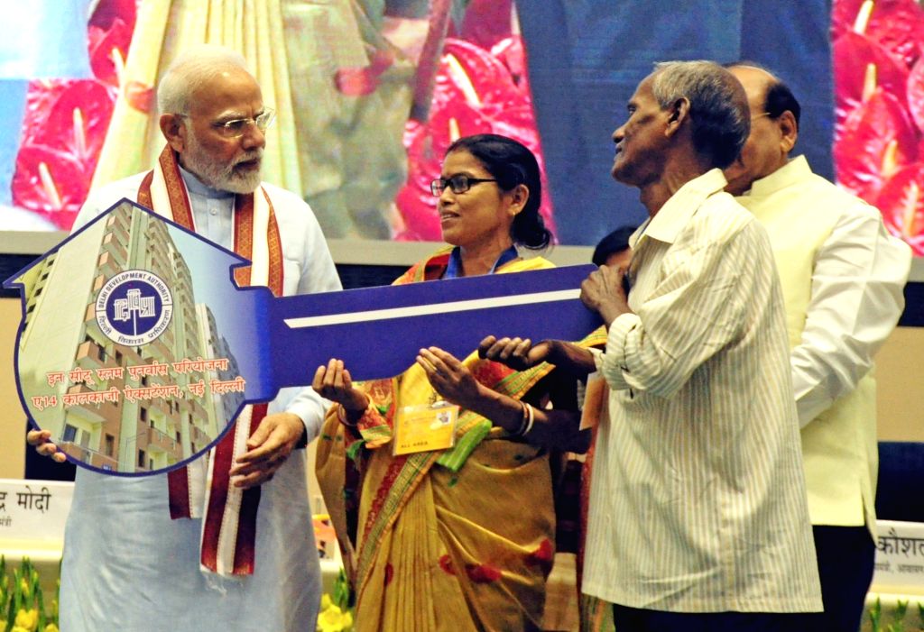 PM Modi hands over a key to eligible beneficiaries