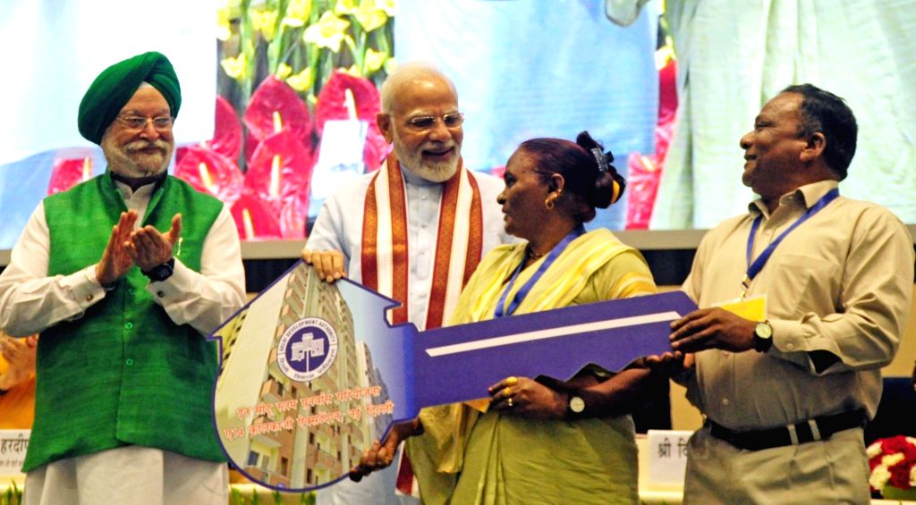 PM Modi hands over a key to eligible beneficiaries