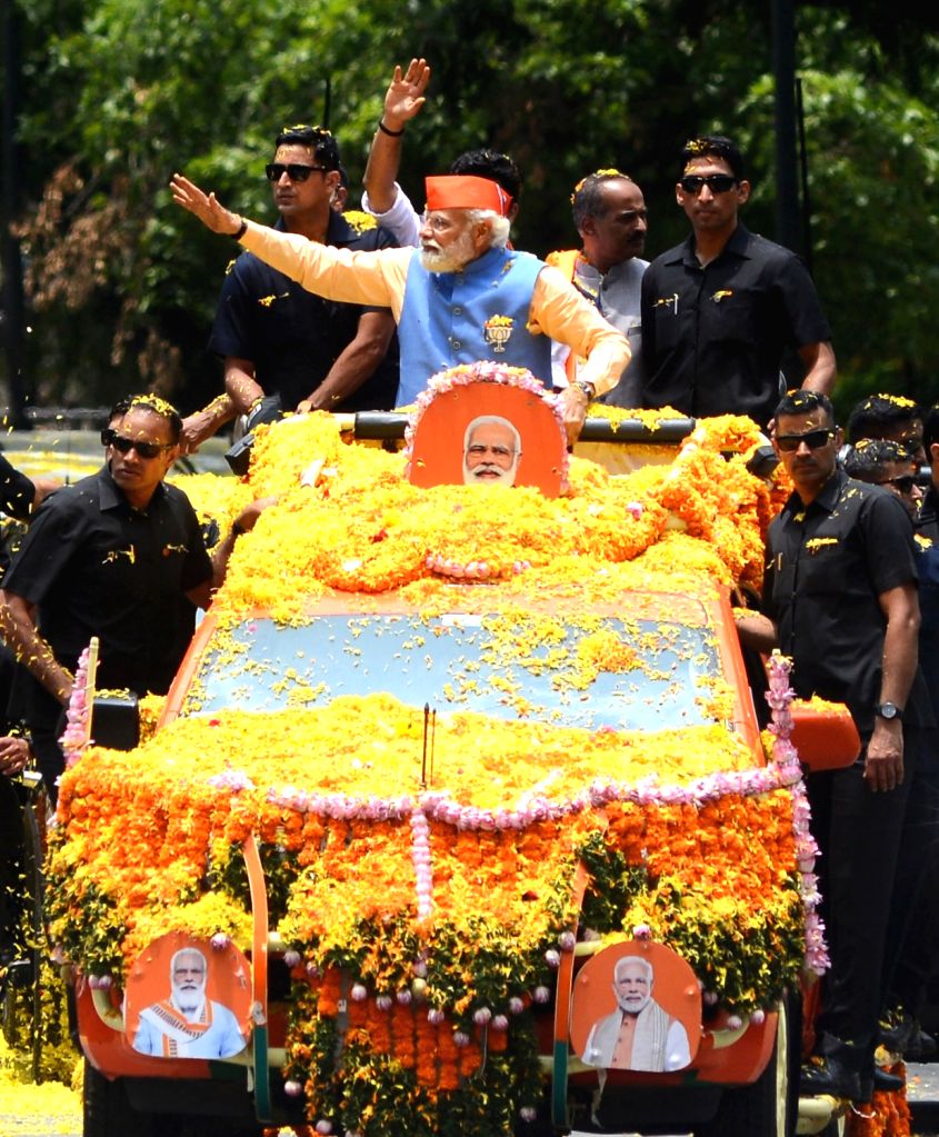Prime Minister Narendra Modi waves at supporters and party workers ...