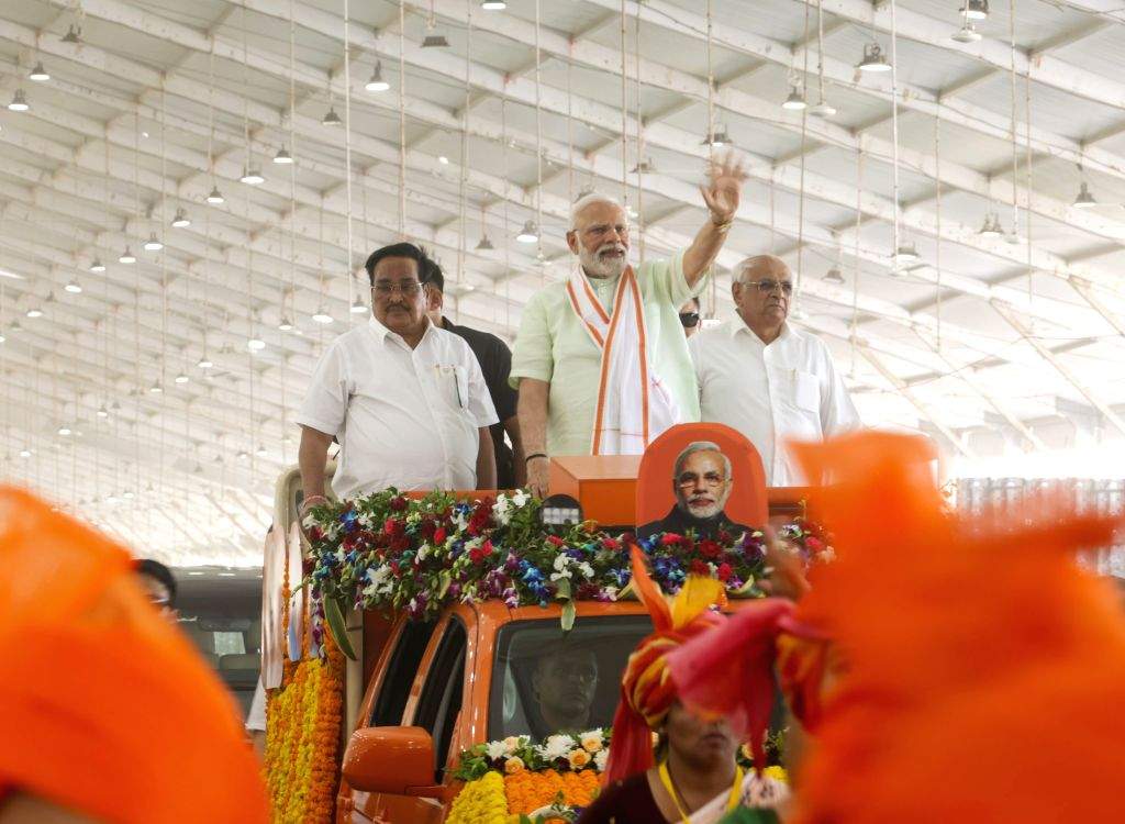 Prime Minister Narendra Modi waves at supporters as he arrives for an ...