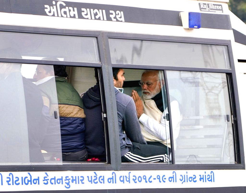 : Gandhinagar: Prime Minister Narendra Modi with mortal remains of his ...