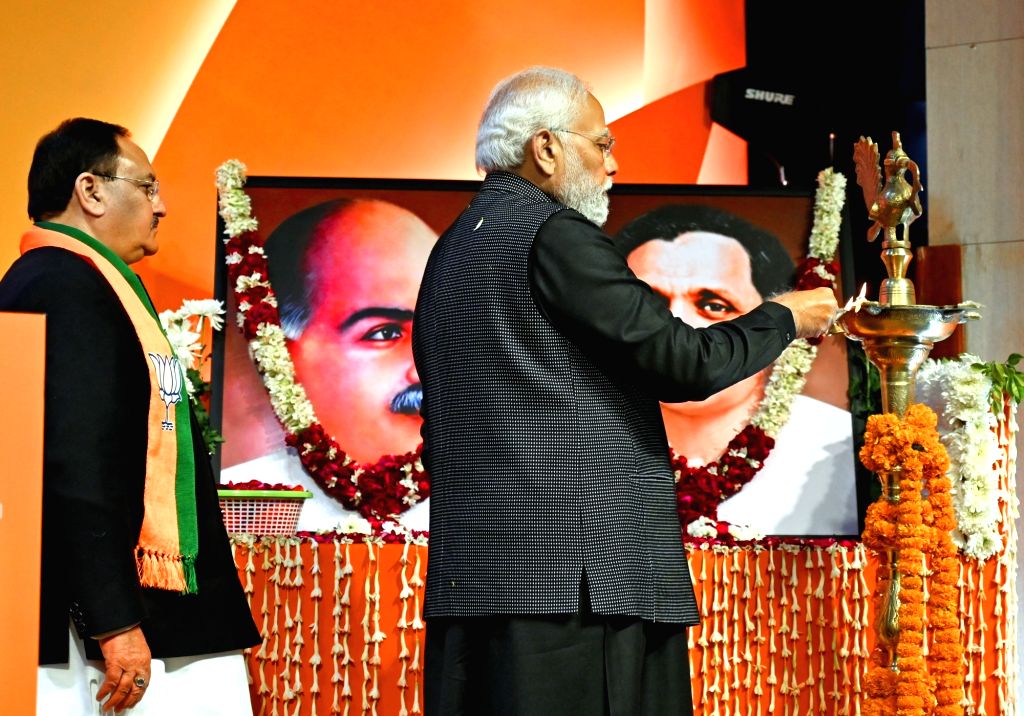 Prime Minister Narnedra Modi lights a lamp