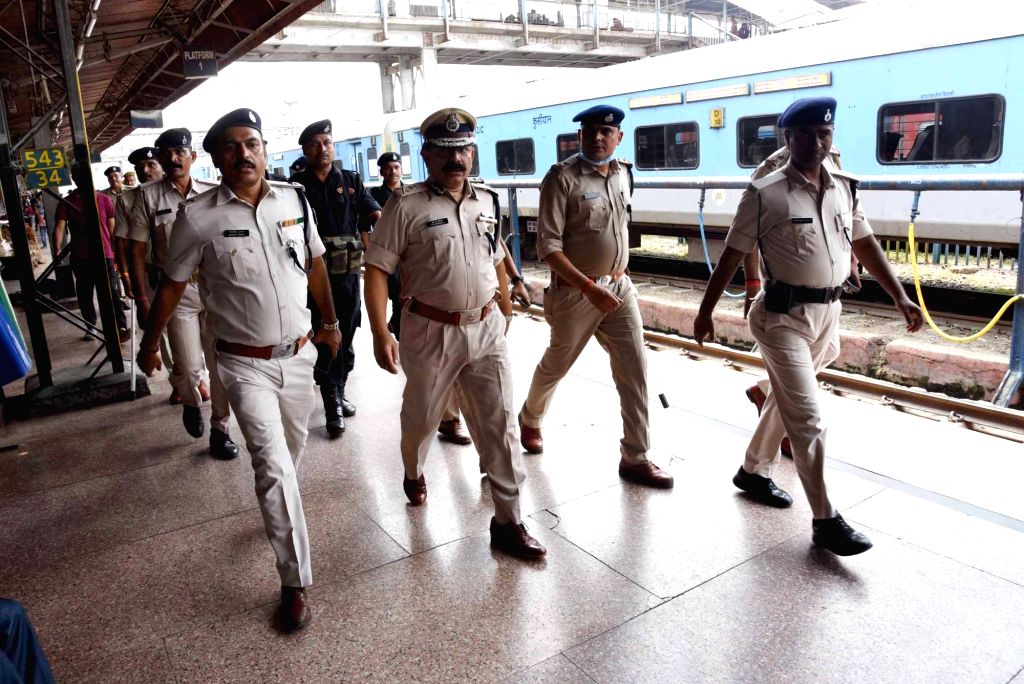 Railway police personnel patrol at Patna Junction railway station.