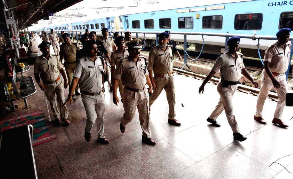 Railway police personnel patrol at Patna Junction railway station.