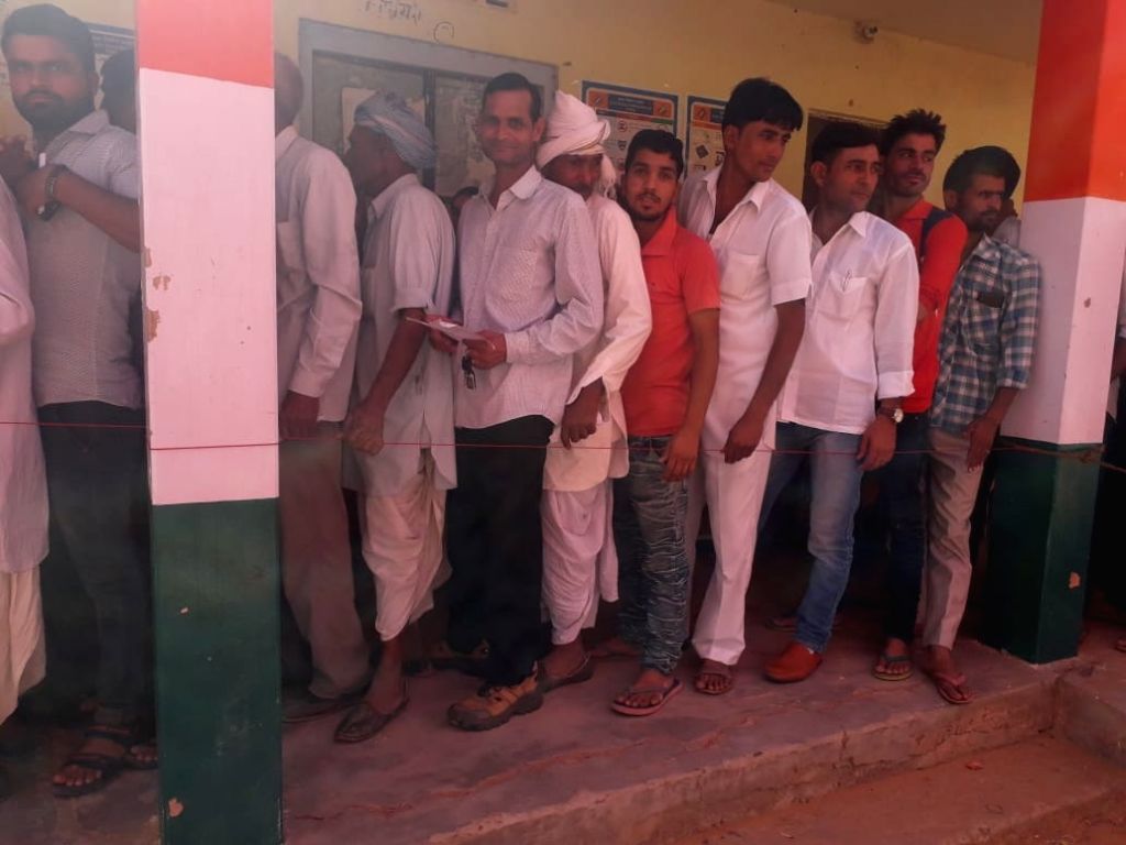 Ranwal (Rajasthan): People stand in a queue to cast their vote at a ...