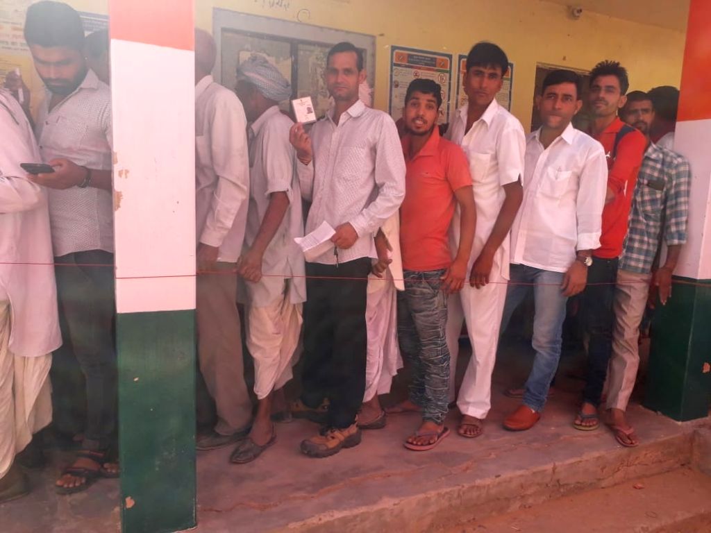 Ranwal (Rajasthan): People stand in a queue to cast their vote at a ...