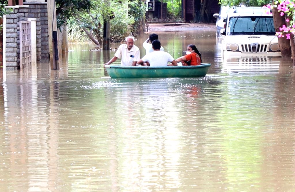 Residentials use a raft to cross a flooded area