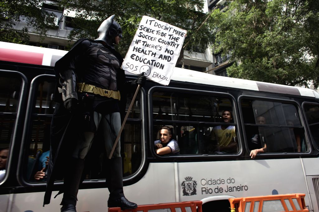 A demonstrator dressed up as Batman attends a protest against the ...