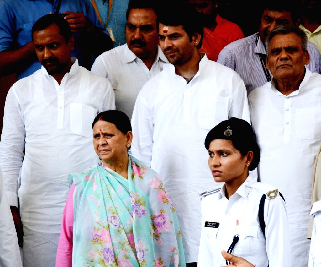 RJD leader Rabri Devi with party leader Tej Pratap Yadav arrive