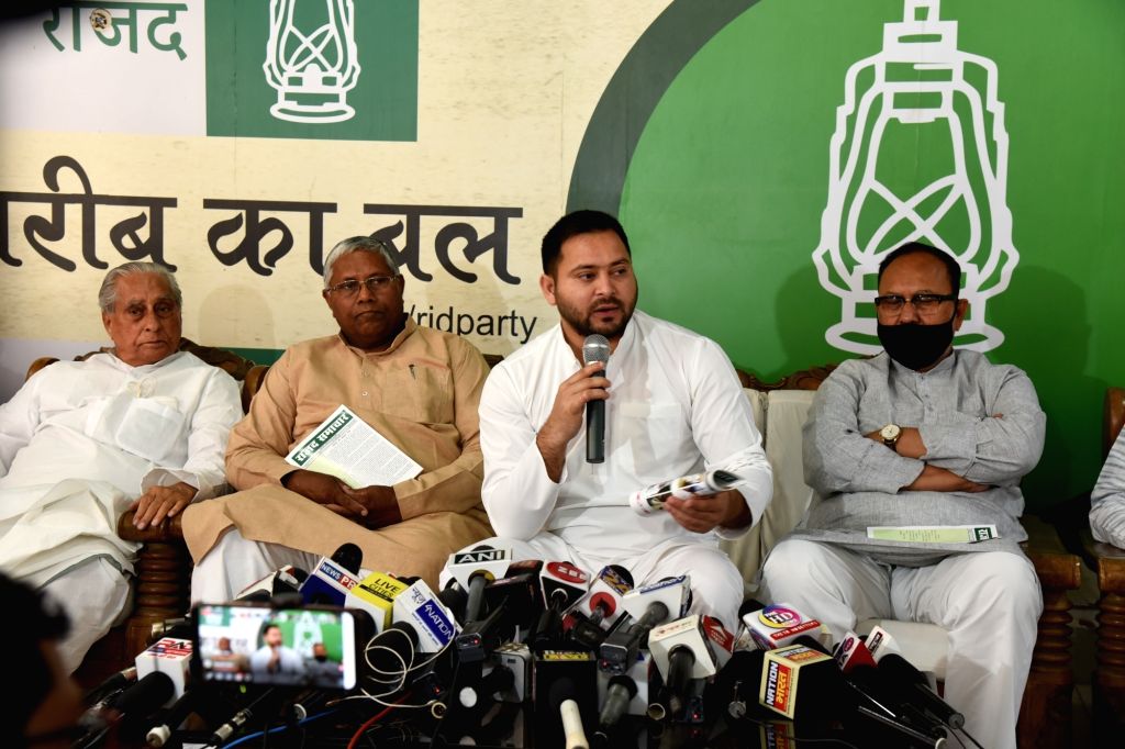 RJD leader Tejashwi Yadav along with other party members addressing ...