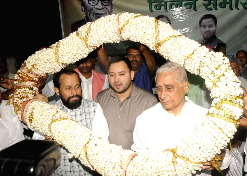 RJD leader Tejashwi Yadav with others being felicitated during a programme