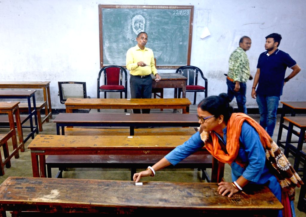 School staff marking on the bench in a classroom