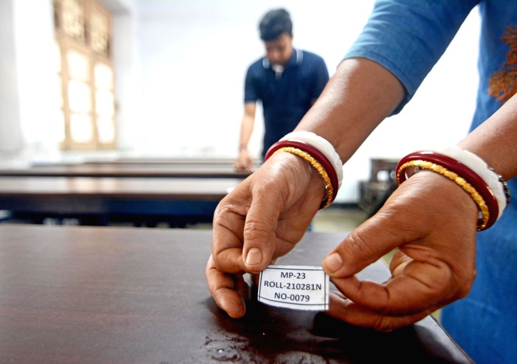 School staff marking on the bench in a classroom