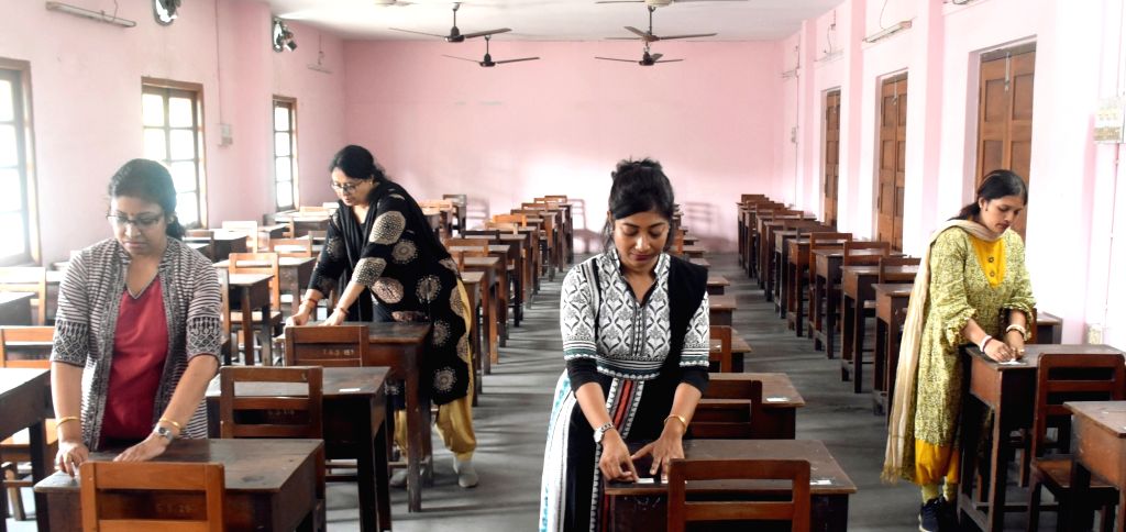 School staff marking on the bench in a classroom