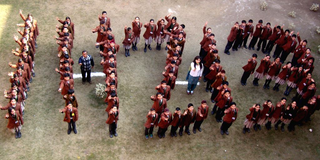 School students stand in the formation of '11/12/13'