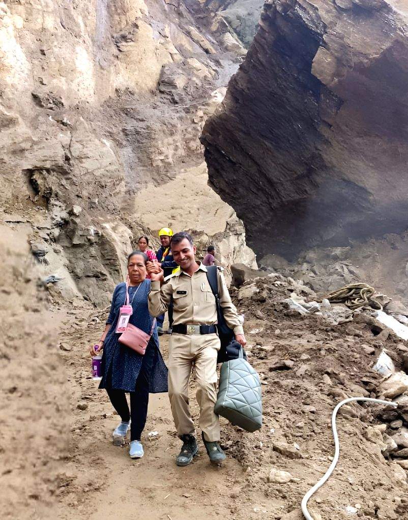 SDRF personnel rescue commuters after huge rocks fell on the road amid ...