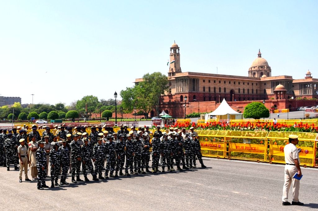 Security and police personnel stand guard