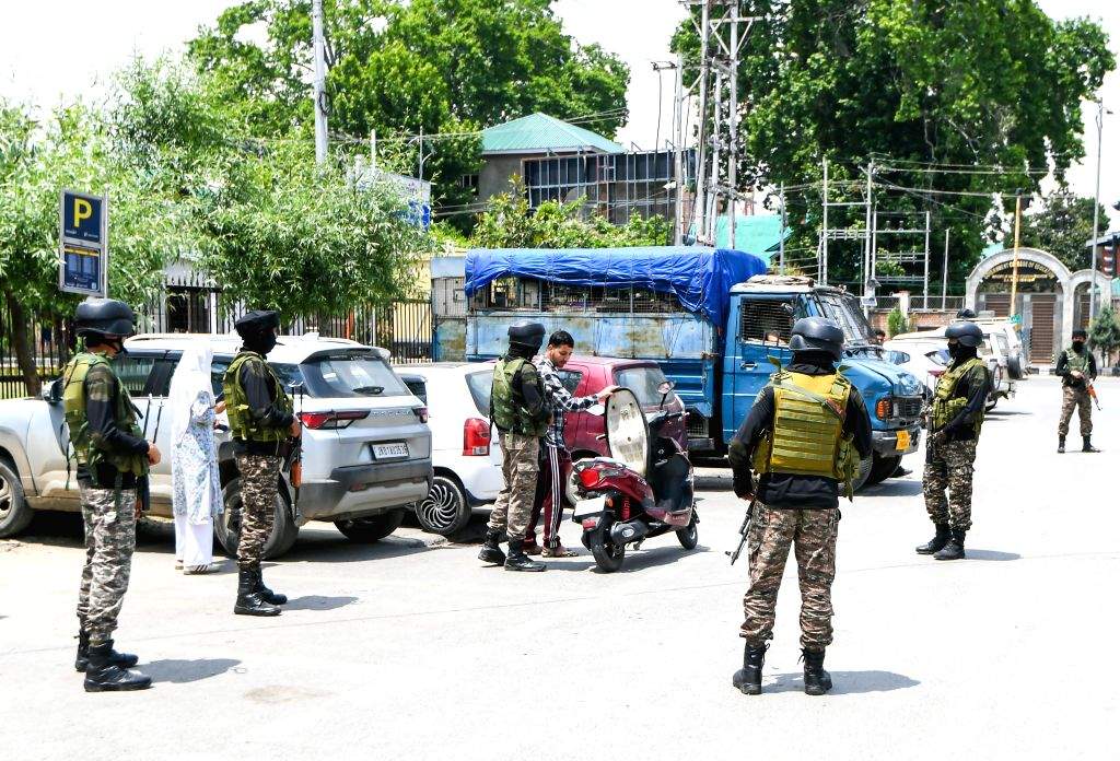 Security personnel frisk vehicles