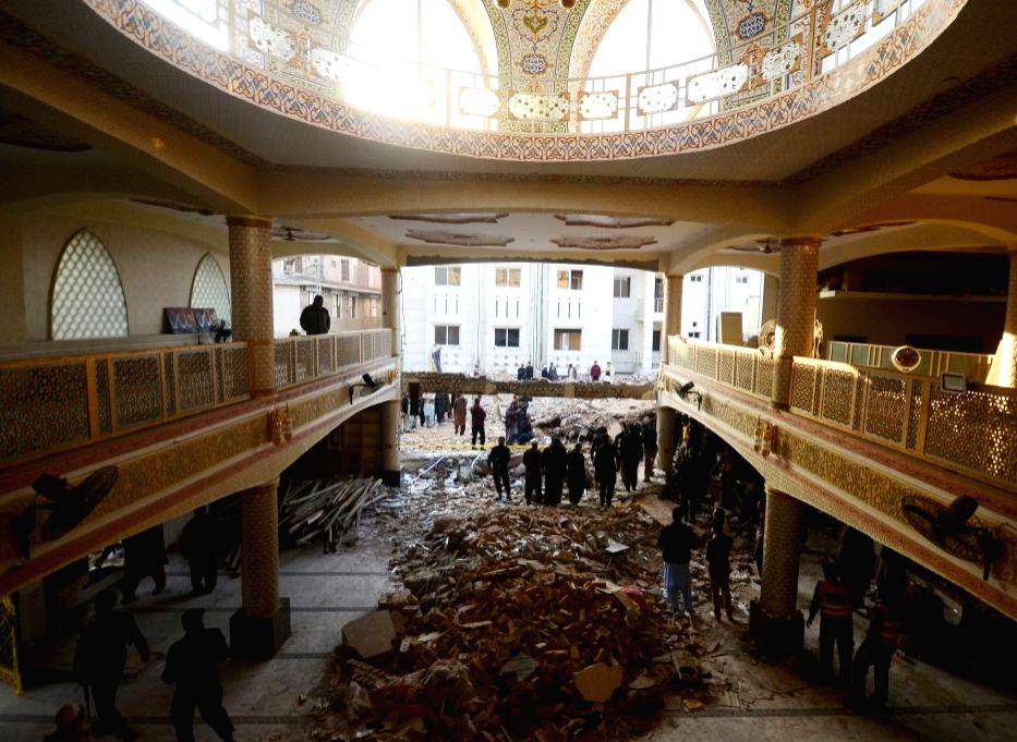 Peshawar :Security personnel inspect a mosque after a blast in Peshawar