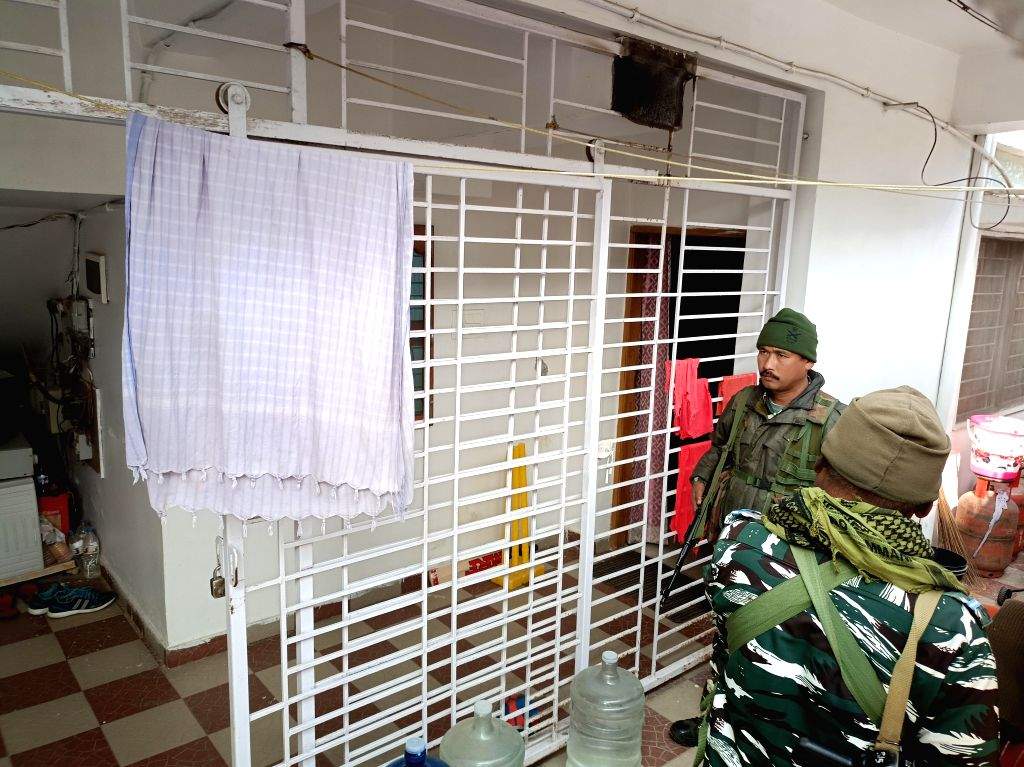 Security personnel stand guard after an ED raid at the residence of ...