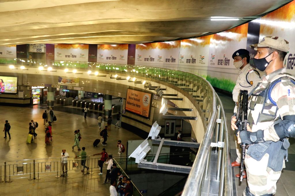 Security personnel stand guard at the Rajiv Chowk metro station